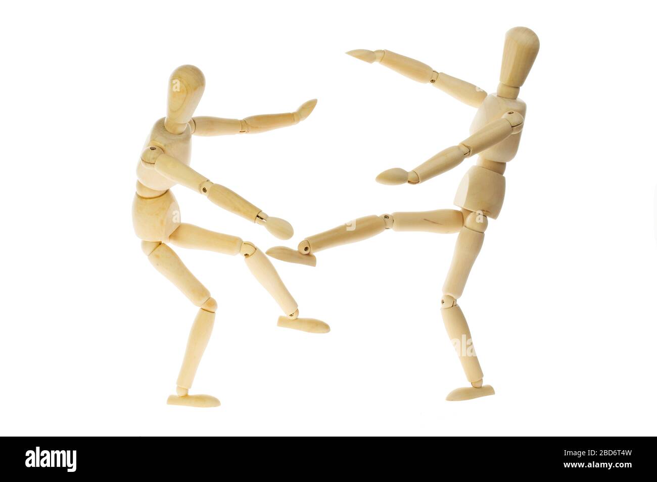 Two wooden artists mannikins fighting, isolated against white Stock ...