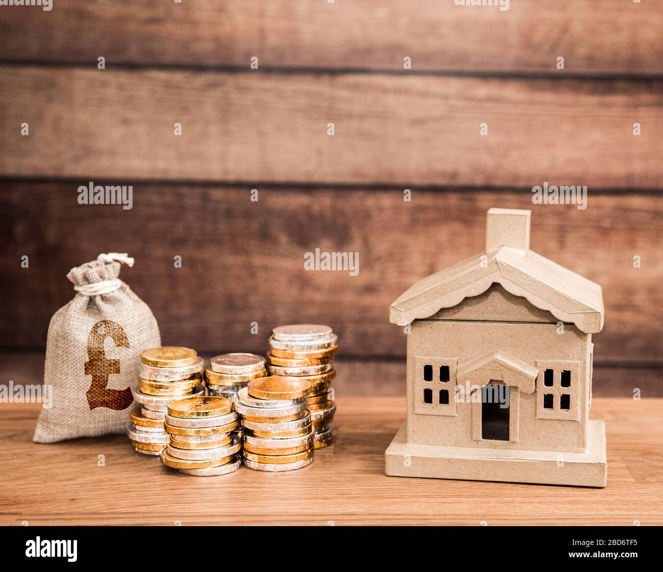 A housing property concept with a home and stacks of money representing ...