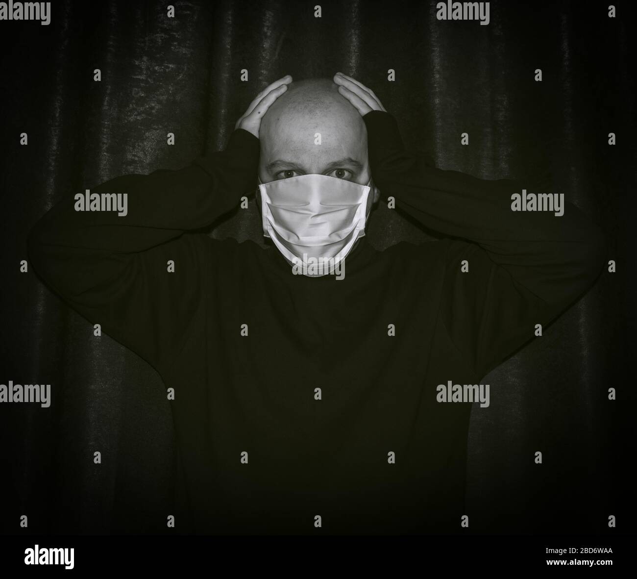 Bald man wearing a face mask in isolation to protect himself against ...