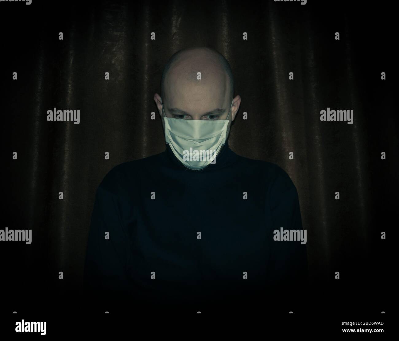 Bald man wearing a face mask in isolation to protect himself against ...