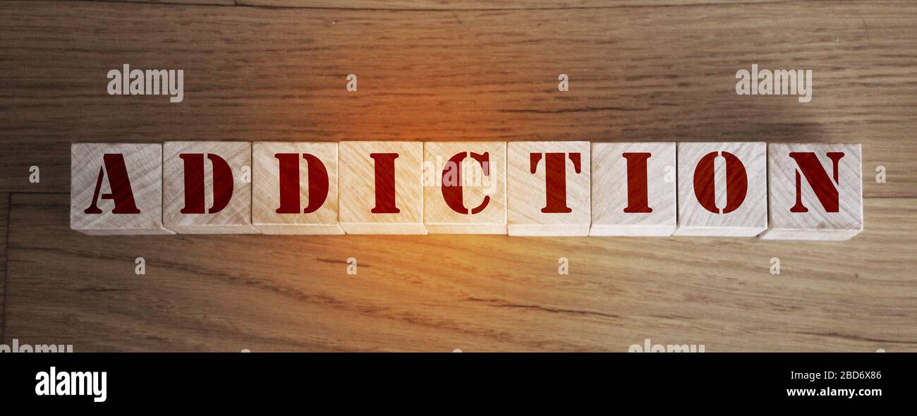 Word Addiction made from wooden letters lies on a wooden background ...