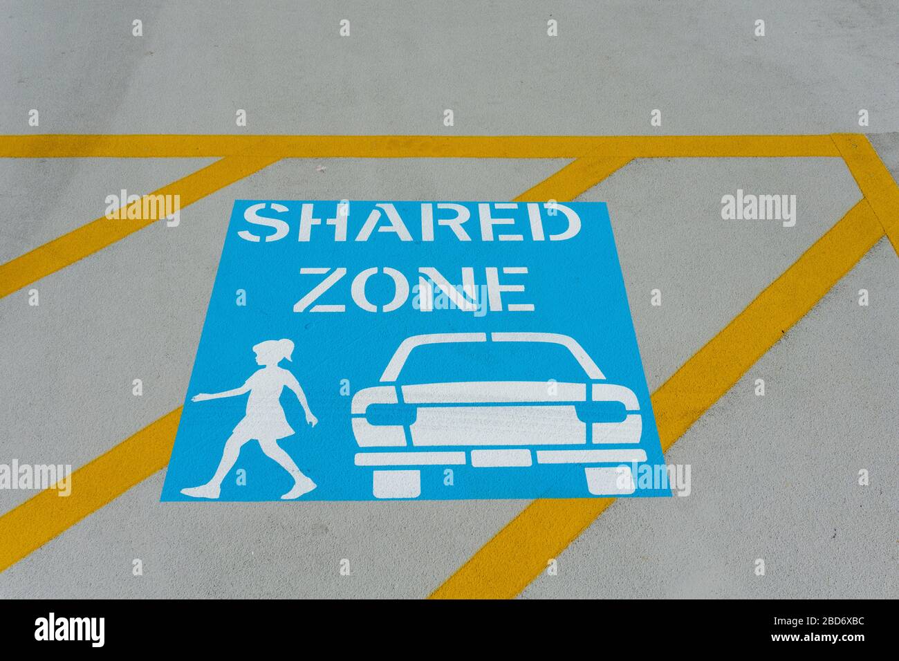 Car and people shared zone sign on ground warning Stock Photo - Alamy