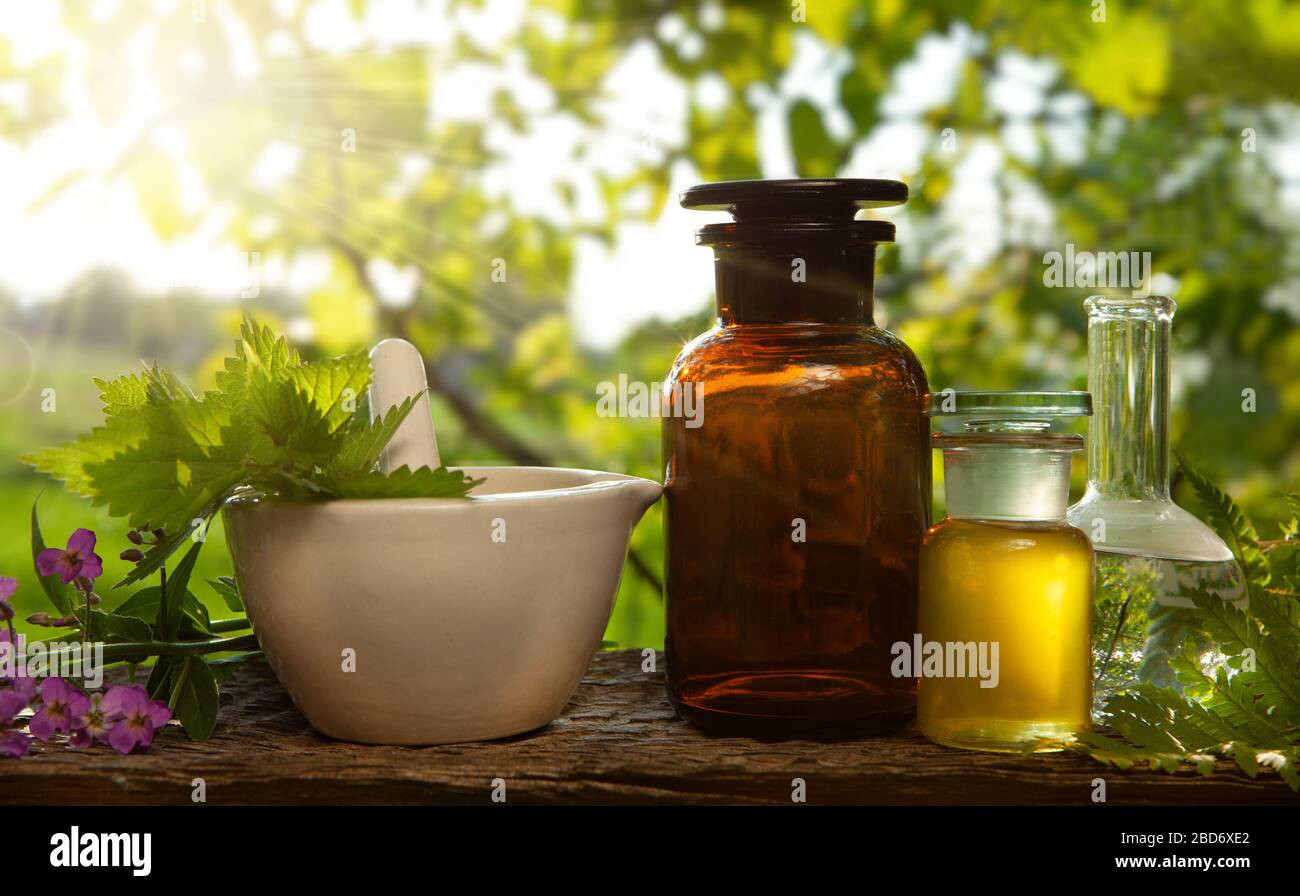 Herbs from the garden and various types of oils for massage and ...