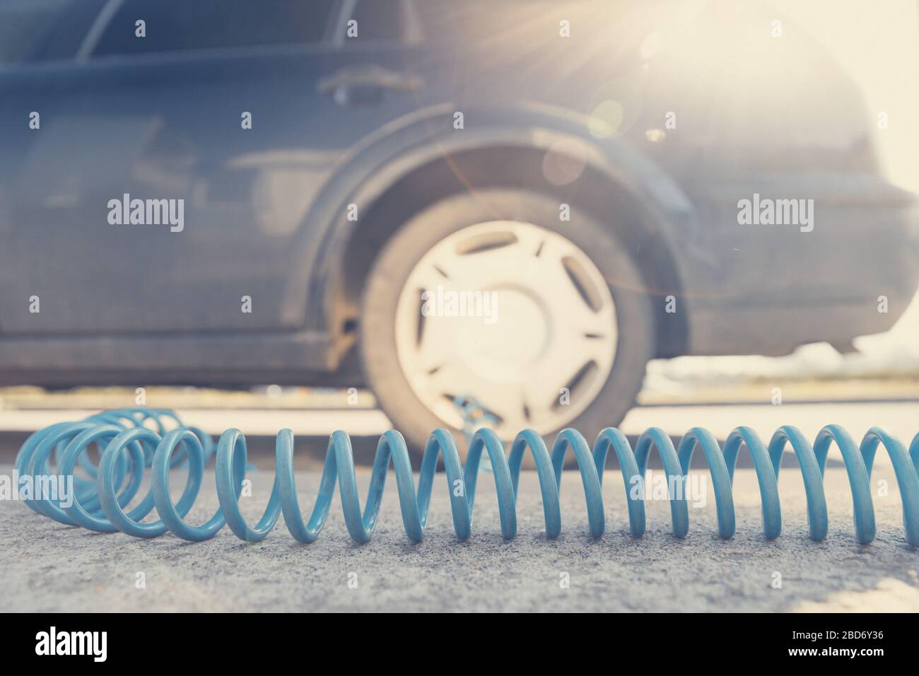 inflating the car tires with air using a compressor Stock Photo - Alamy
