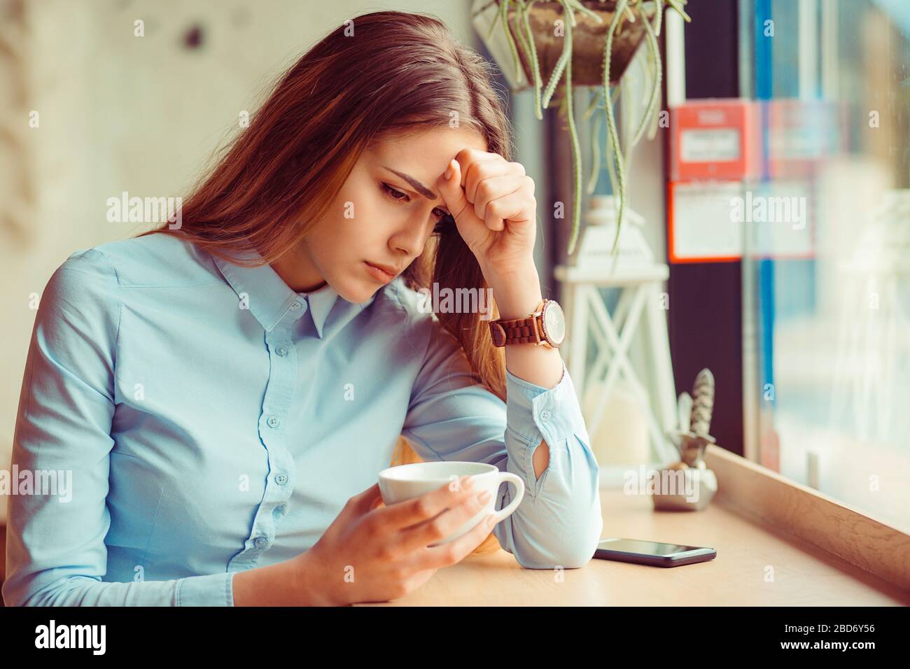 Stress. Portrait stressed sad young woman with coffee cup sitting in a ...