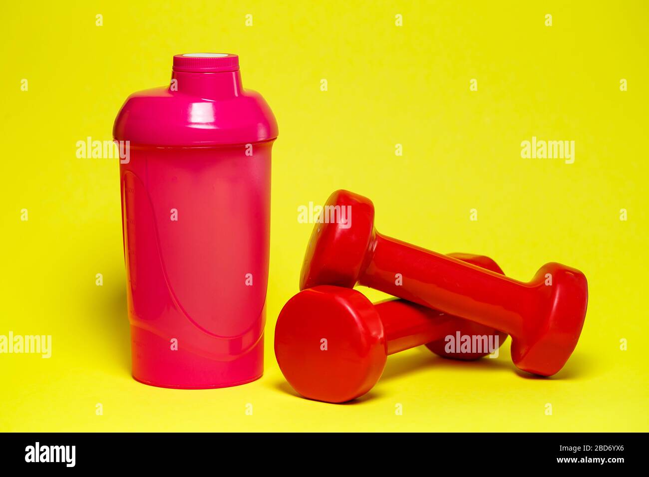 red dumbbells, pink shaker, colored background, sports, energy drink ...