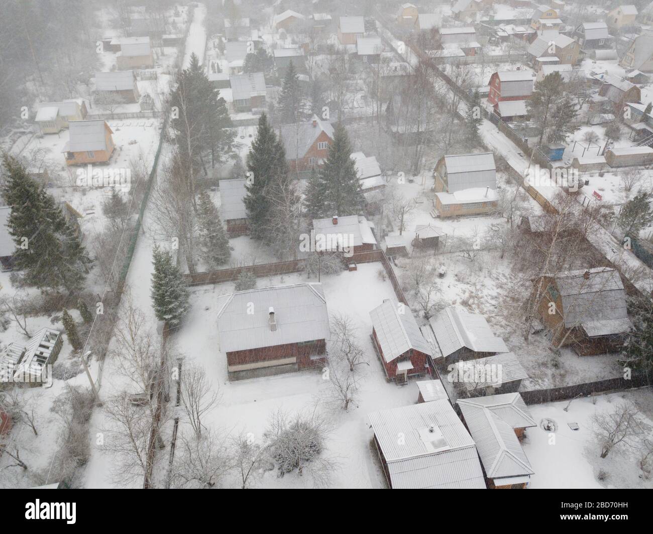 A small town under a snowfall, aerial view Stock Photo - Alamy