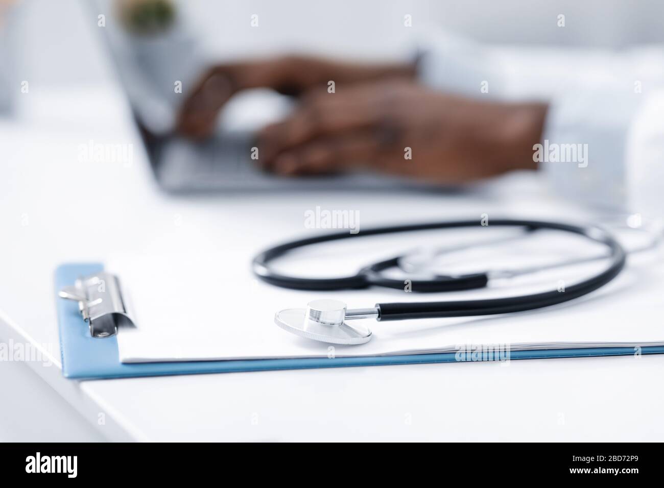 Stethoscope on medical chart over working with laptop doctor Stock ...