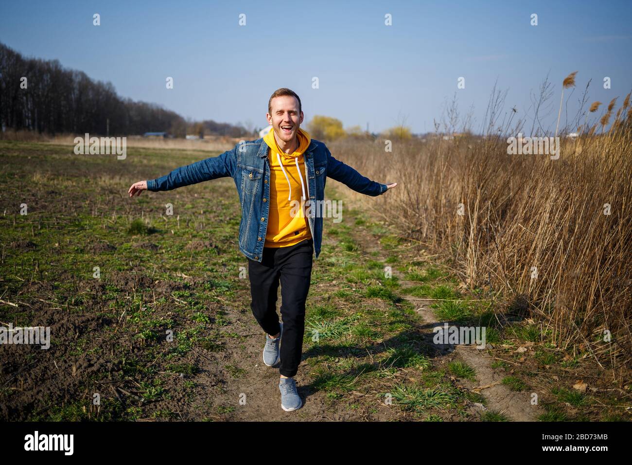 Smiling man enjoying wind blowing in forest. Happy man feeling joy ...