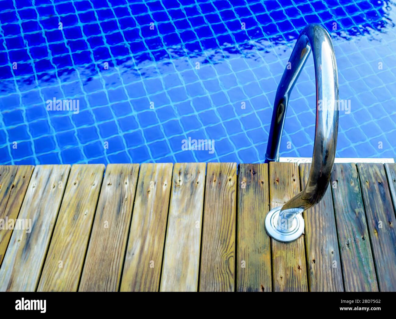 Chrome ladder rail on a poolside deck Stock Photo - Alamy