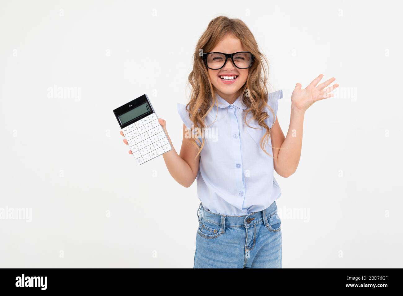smart teen girl holding a calculator in hand on a white background with ...