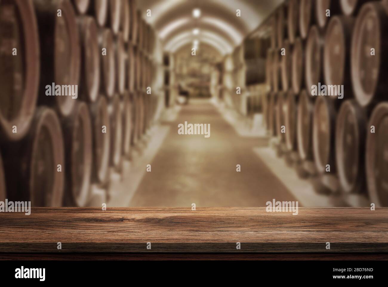 Empty wooden table with blurry background wine barrels in the wine ...