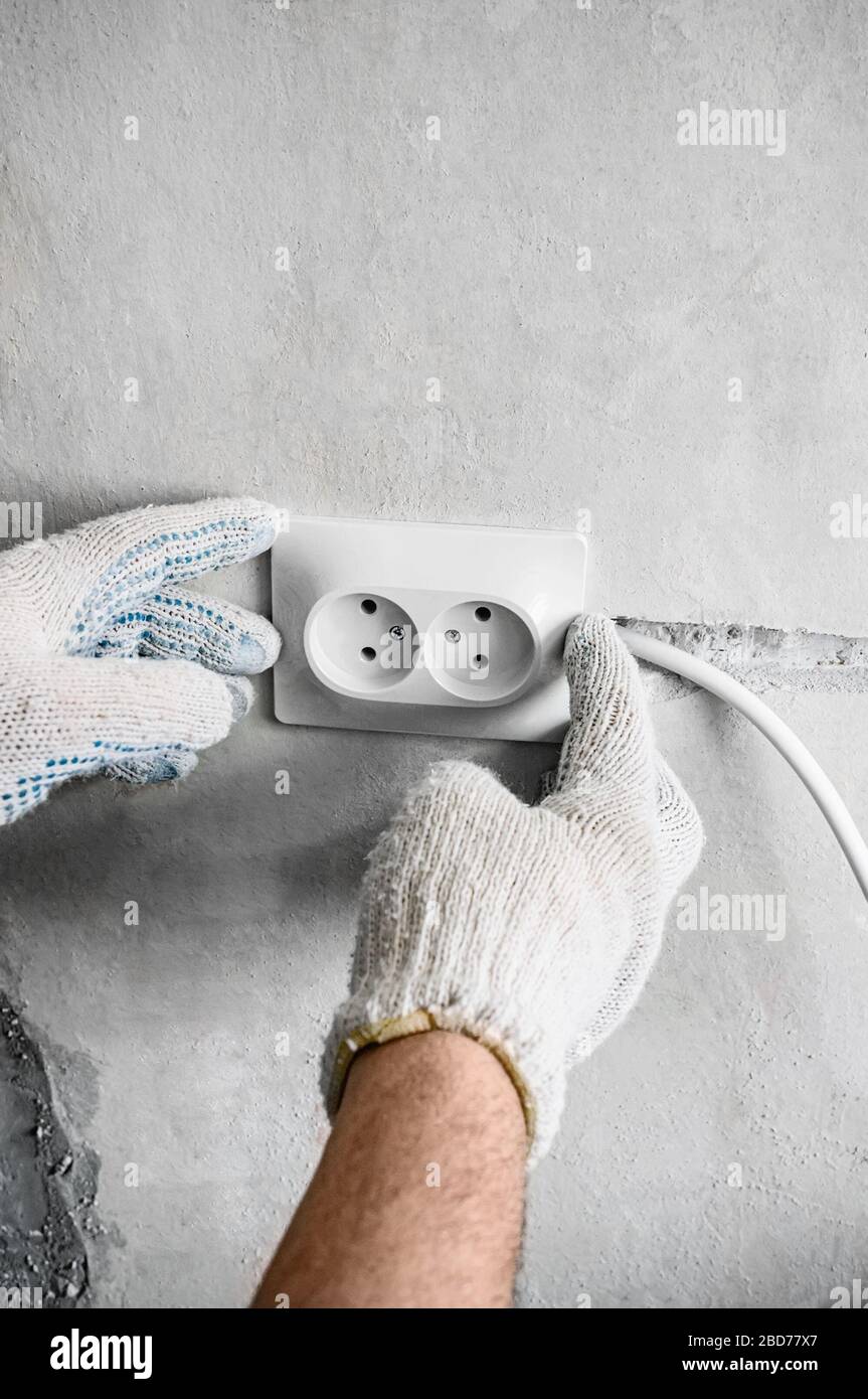 Work on the installation of electrical outlets. The wizard replaces the ...