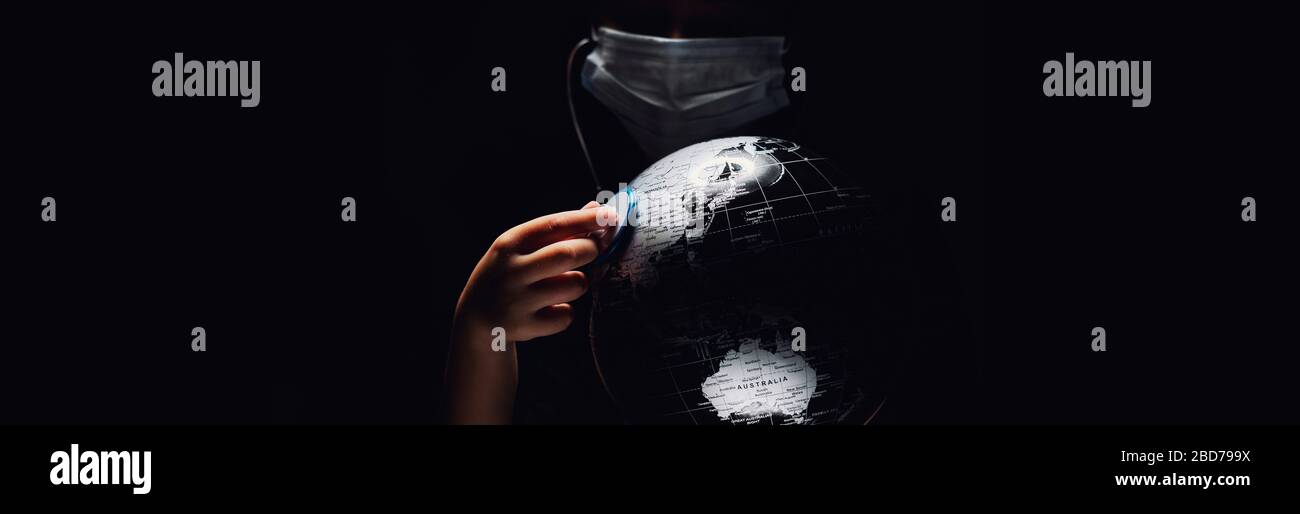 Kid hold globe put stethoscope on sphere, face covered in mask on black ...