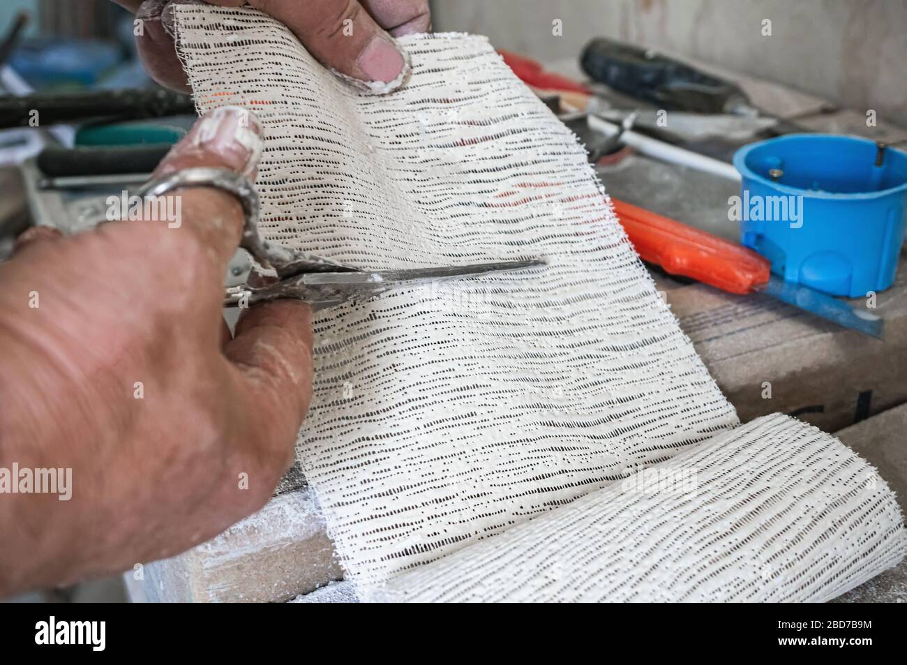 The plaster cast is prepared for application and fixation. Scissors cut ...