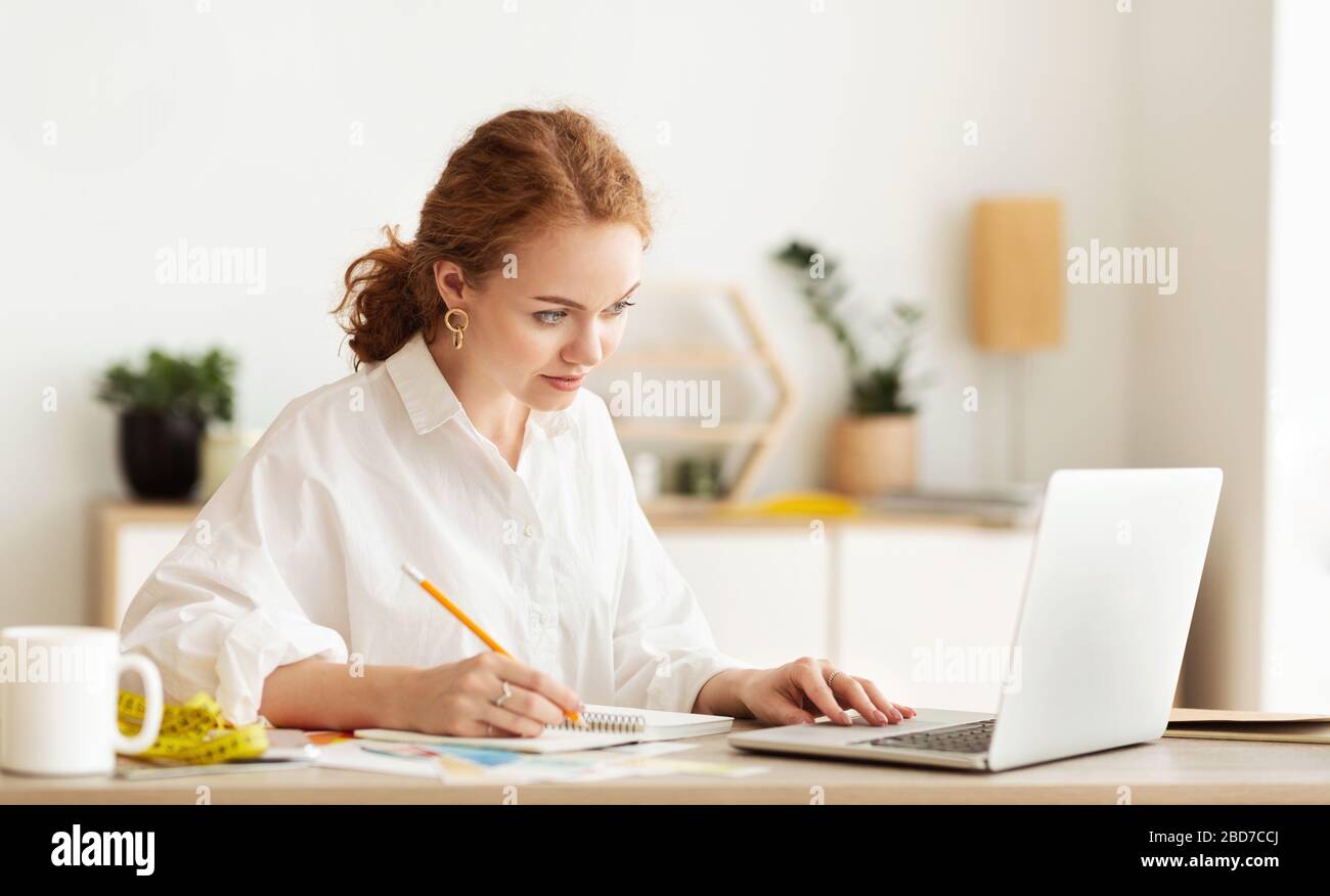 Tailor using personal computer laptop at home Stock Photo - Alamy