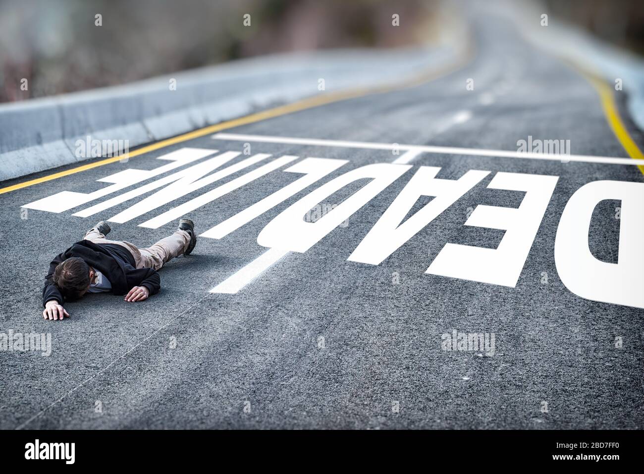 Tired powerless man in black jacket and grey trousers fallen on road ...