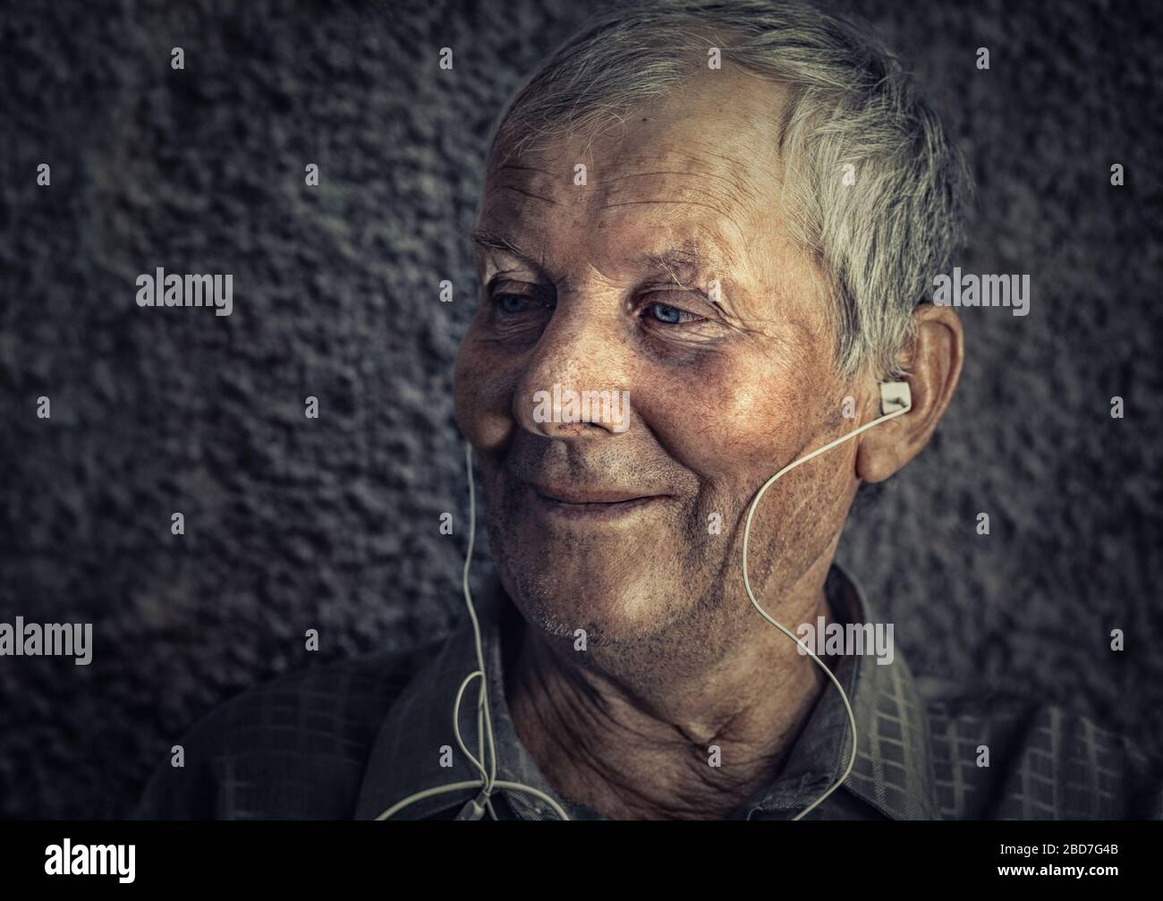Closeup portrait cropped image of Senior old man listening to music on ...