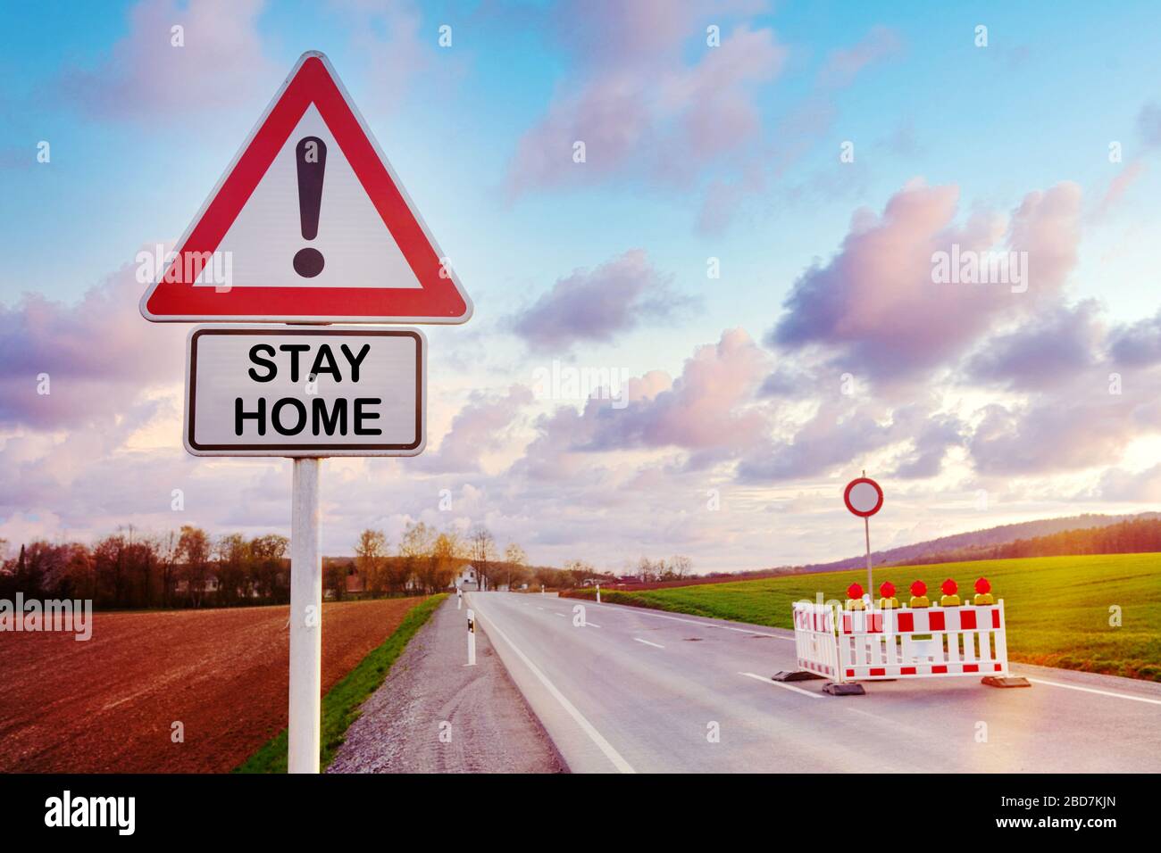 road sign with exclamation point and the words Stay Home Stock Photo ...