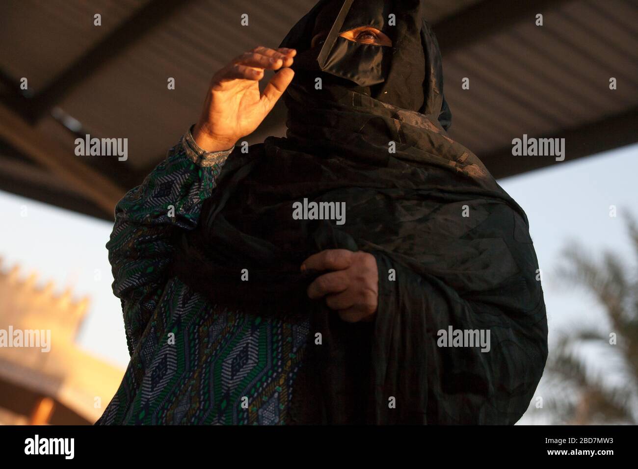 Omani women wearing a Batoola haggle for livestock at the friday market ...