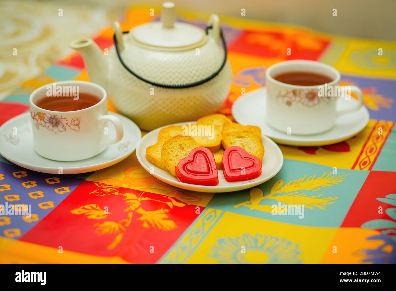 Time for a tea break. 2 cups of hot drink, tasty cookies, heart shaped ...