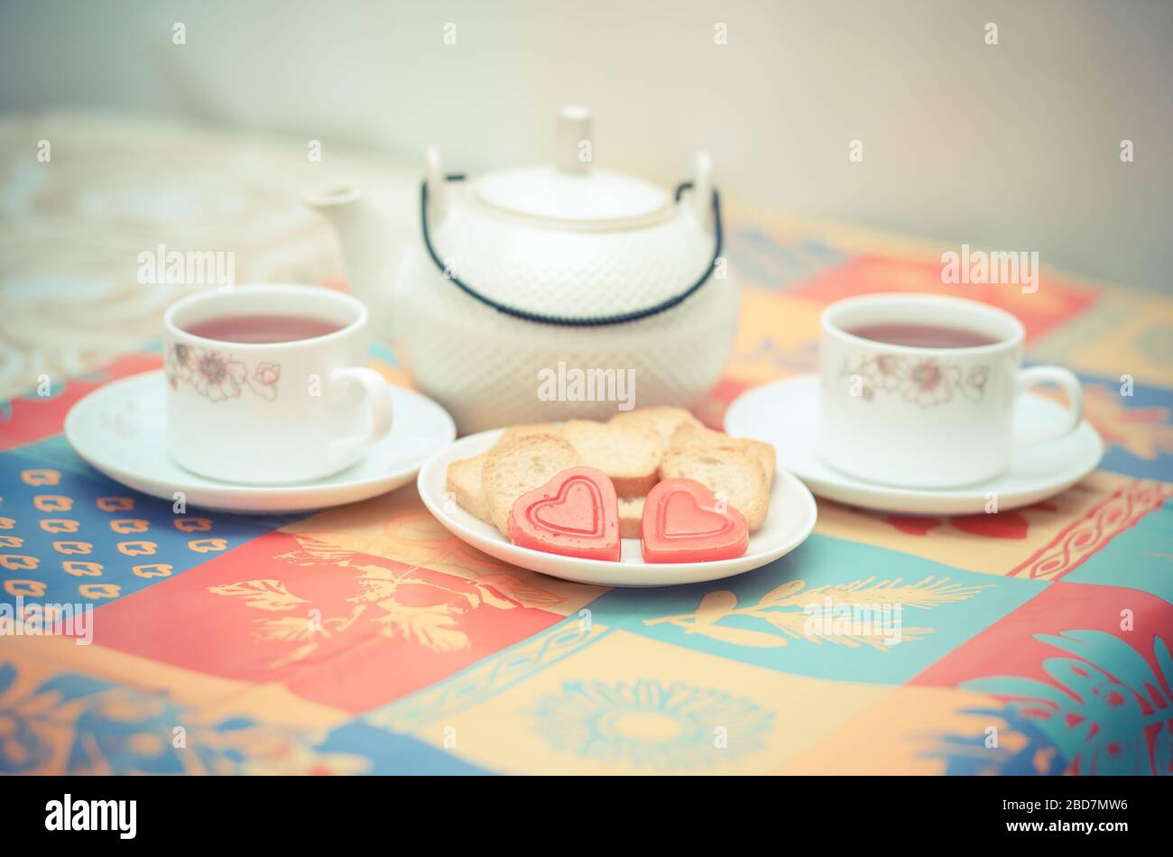 Time for a tea break. 2 cups of hot drink, tasty cookies, heart shaped ...