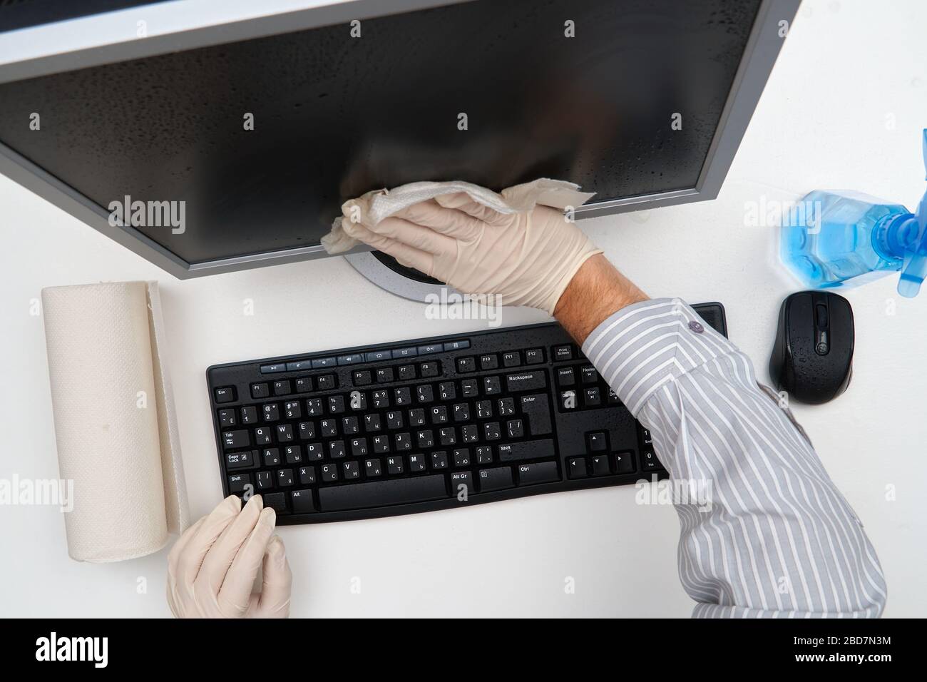 concept of cleaning or disinfecting the office - a businessman cleans ...