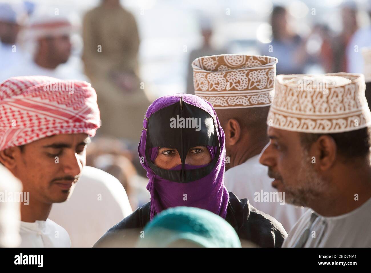 Omani women wearing a Batoola haggle for livestock at the friday market ...