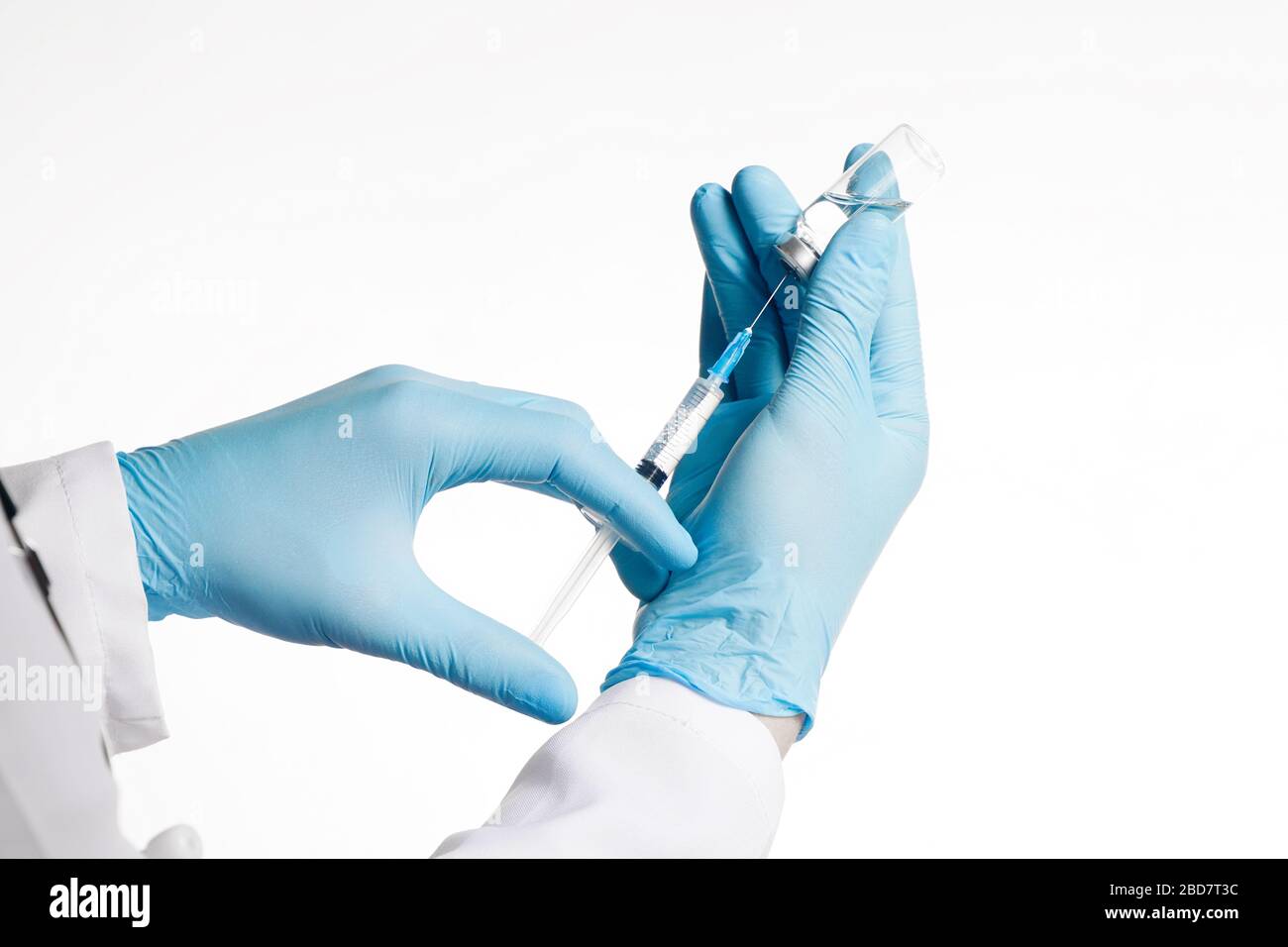 Close up doctor arm using syringe and ampoule on white background ...