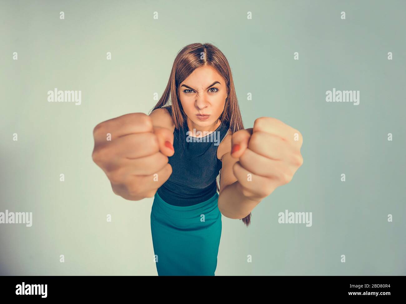 Closeup portrait angry young woman showing fists about to punch hit ...