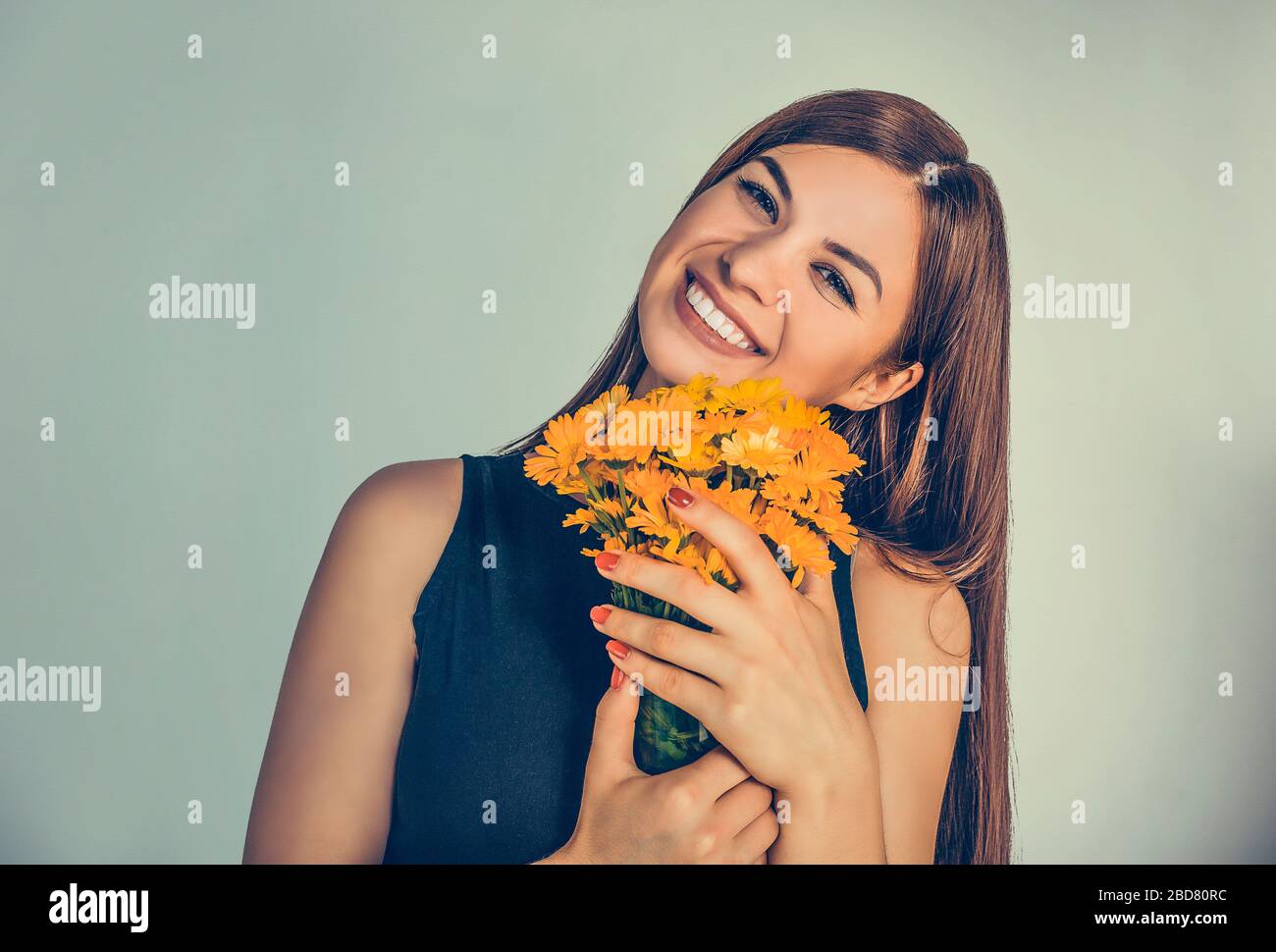 Beautiful smiling girl, woman holding bouquet of marigold, calendula ...