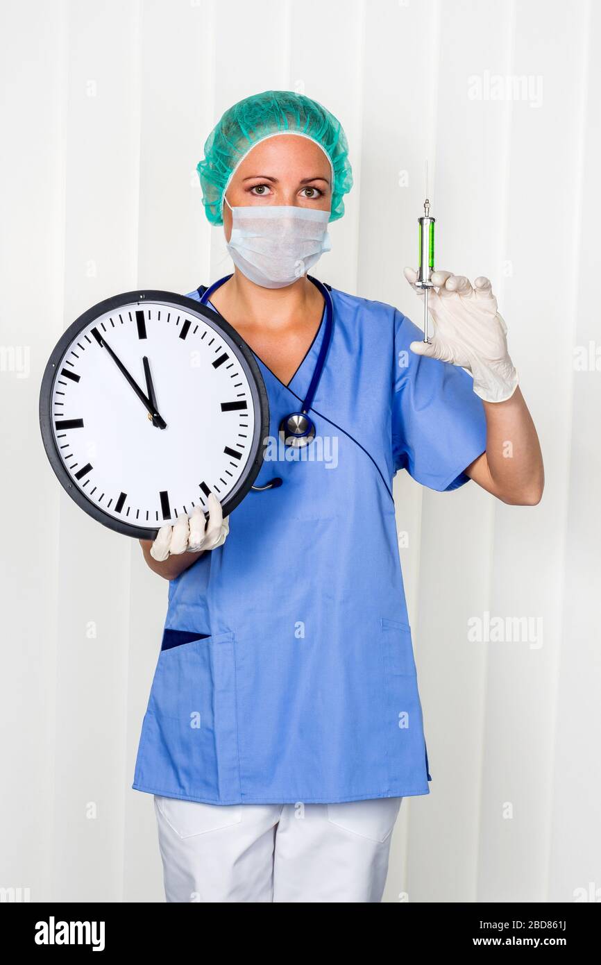 female surgery doctor in srubs, holding a clock, 5 before 12, symbol ...