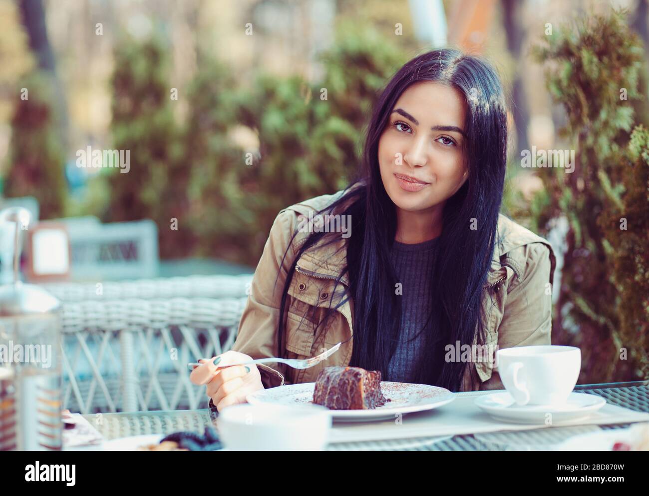Woman happy eating. Closeup portrait beautiful smiling slightly ...