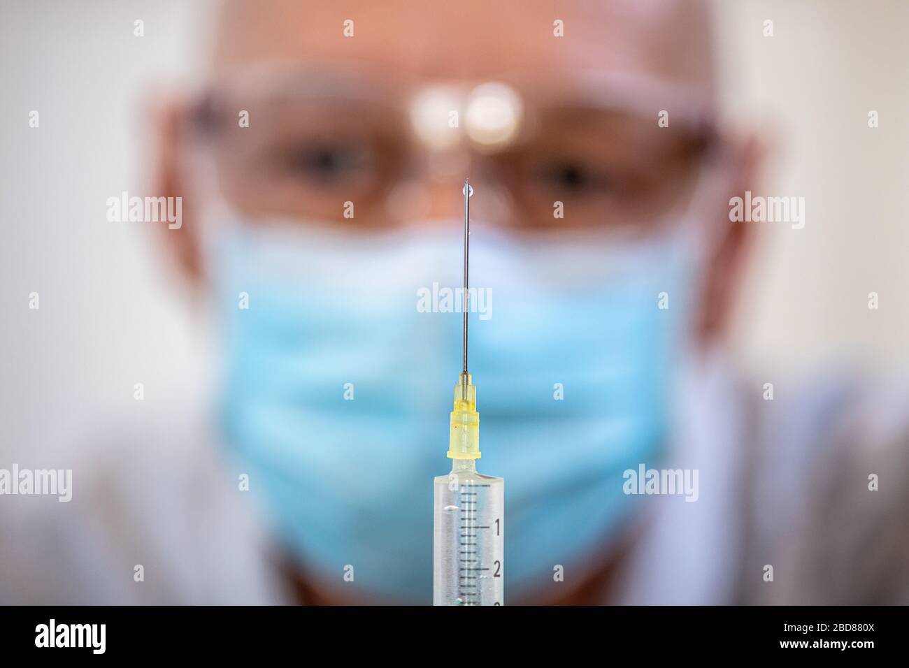 Leipzig, Germany, 07-04-2020 a doctor with an injection syringe and a ...