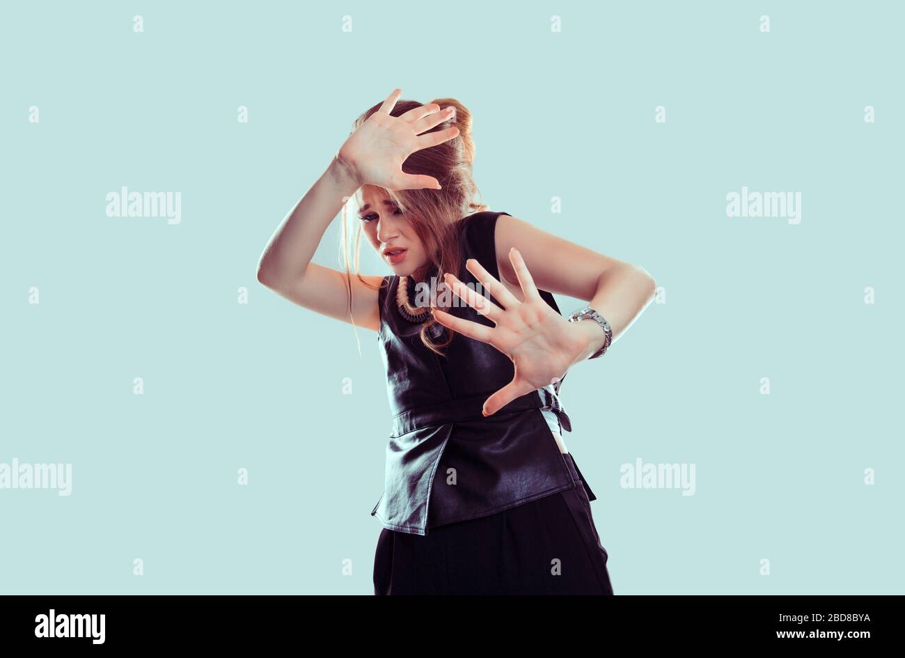 scared woman raising hands up in defense afraid about to be attacked or ...