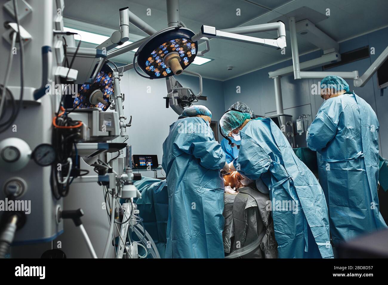 A team of professional surgeons works in the operating room. A real ...