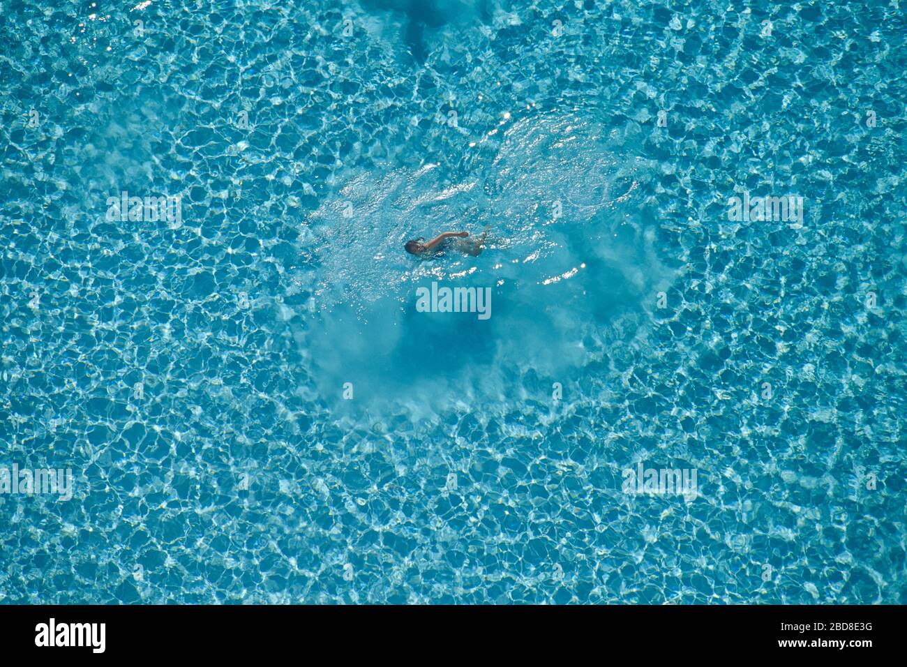 Social distancing, woman swimming in outdoor hotel pool. Las Vegas ...