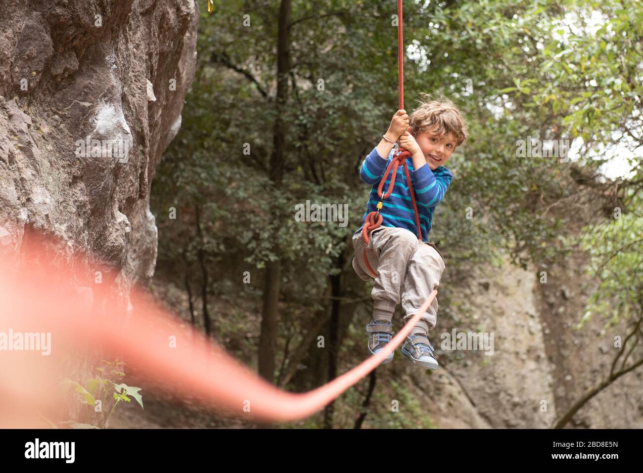 Four year old toddler swings hanging from a climbing rope Stock Photo ...