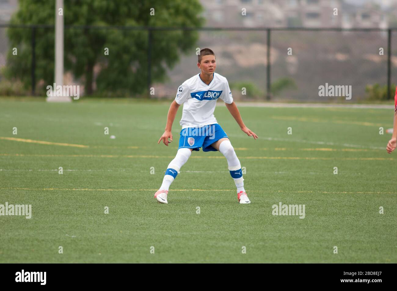 Teen soccer defender in the ready position during a game Stock Photo ...