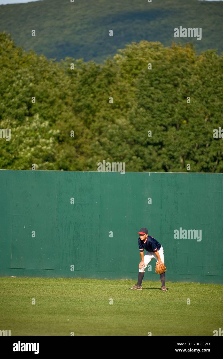 Boy in ready position in the outfield of a baseball field Stock Photo ...