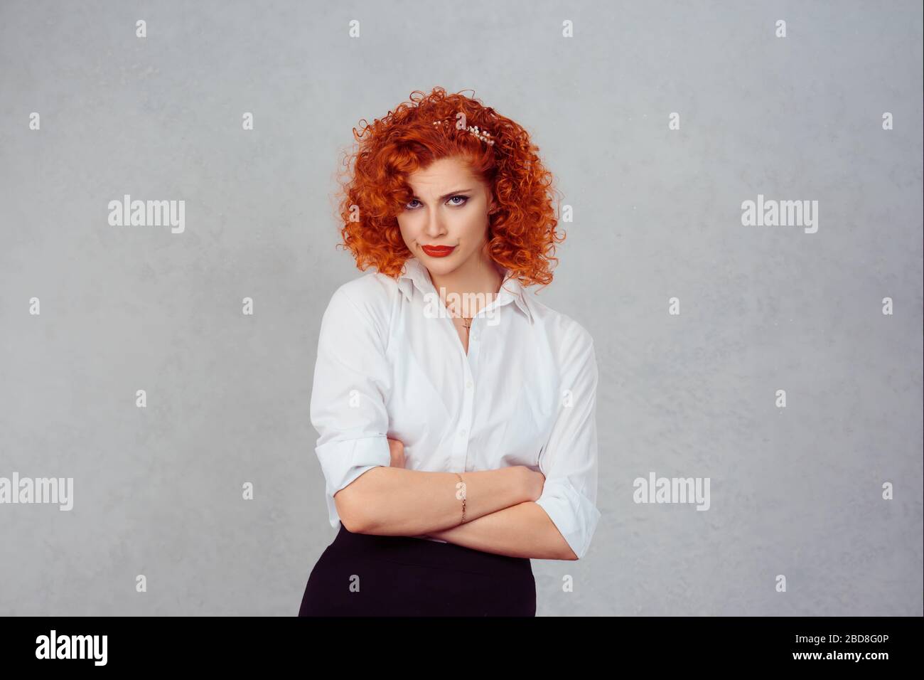 Grumpy girl. Closeup portrait young serious angry redhead curly ginger ...