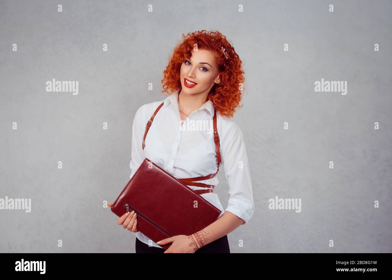 Corporate employee, worker. Portrait of a cute attractive young red ...