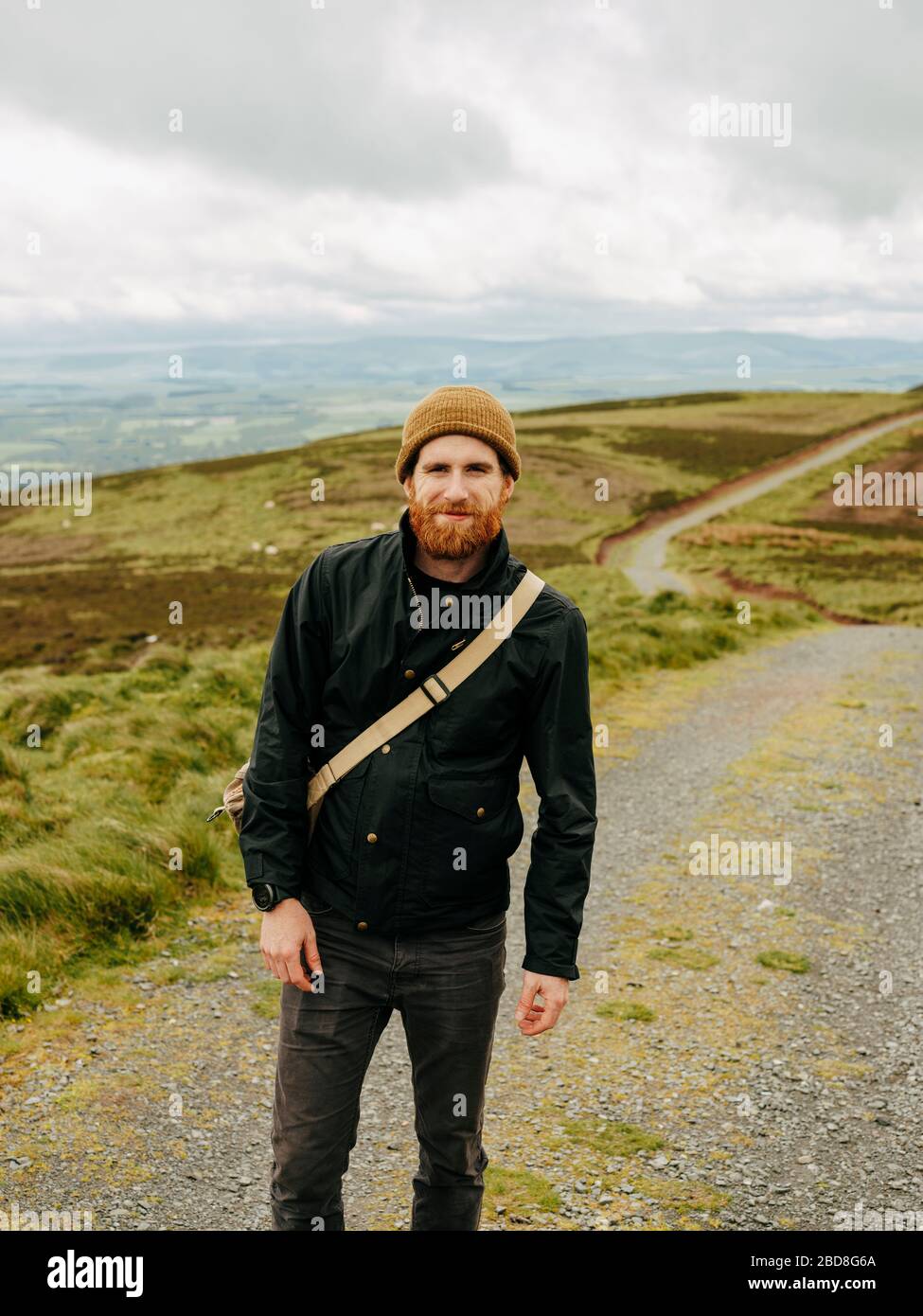 Smiling bearded man on country gravel road Stock Photo - Alamy