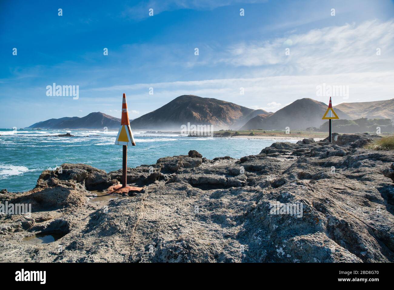 Maritime sign posts embedded in coastal rock Stock Photo - Alamy