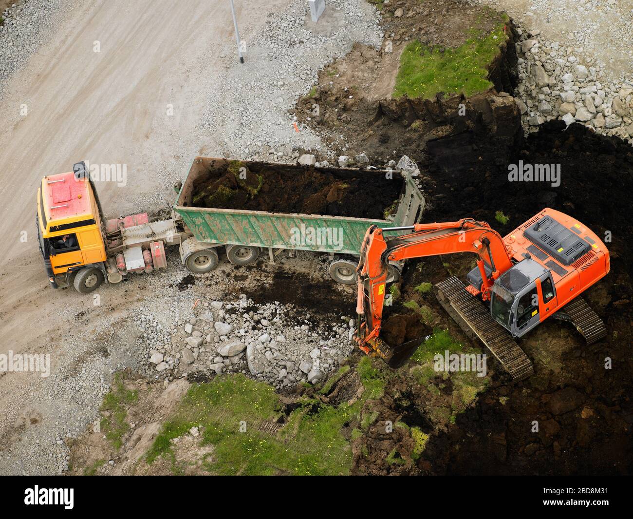 Aerial shot of earth mover filling dump truck at building site Stock ...