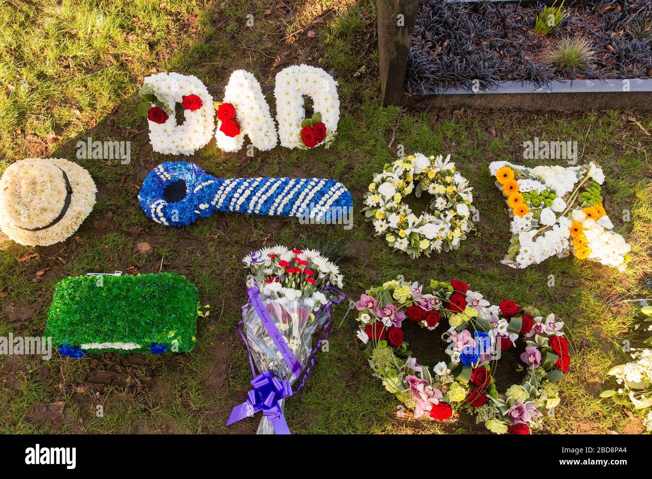 Floral tributes at a cemetery Stock Photo - Alamy