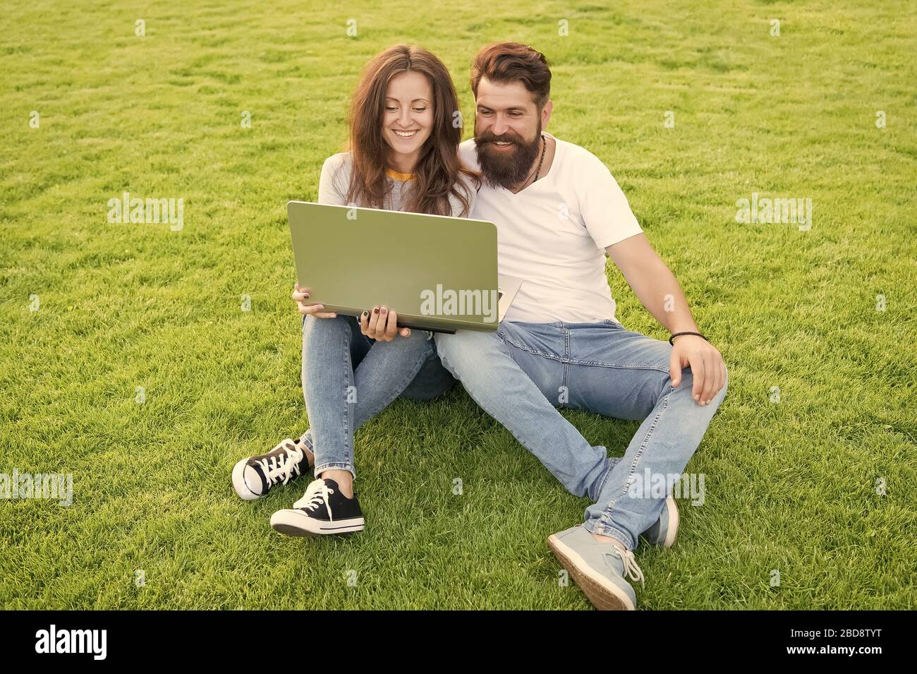 Towards knowledge. working on computer in park. man and woman surfing ...