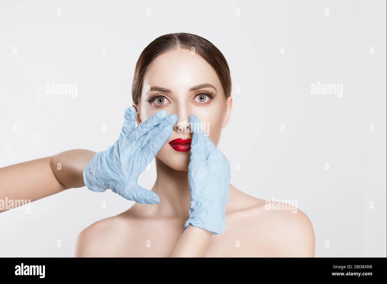 Doctor hands correct nose woman hi-res stock photography and images - Alamy