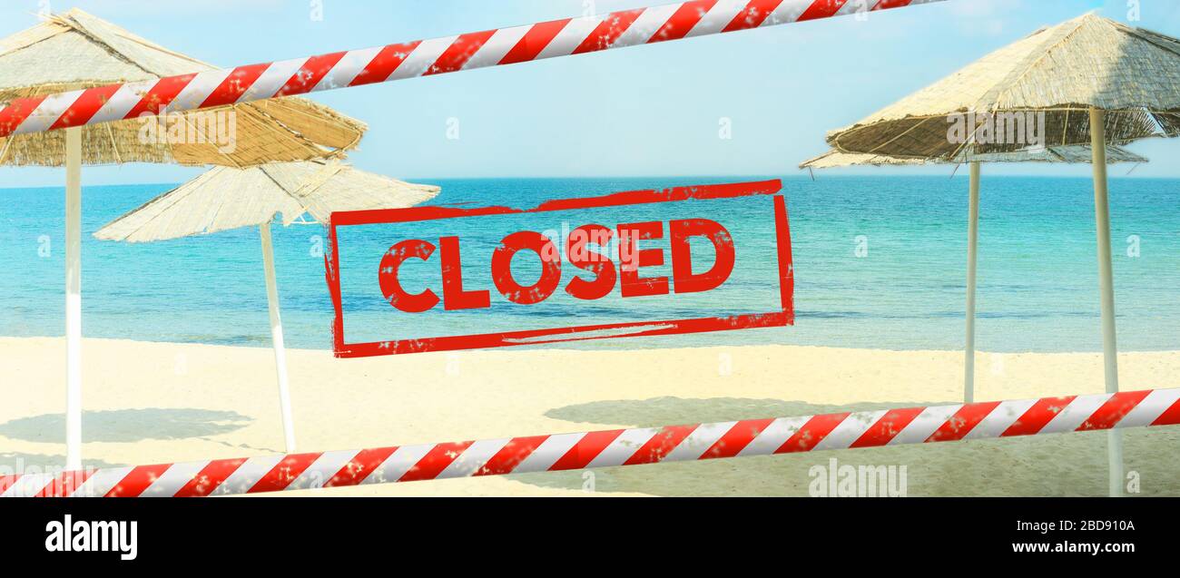 Red inscription "closed" on a blurred background of a deserted beach ...