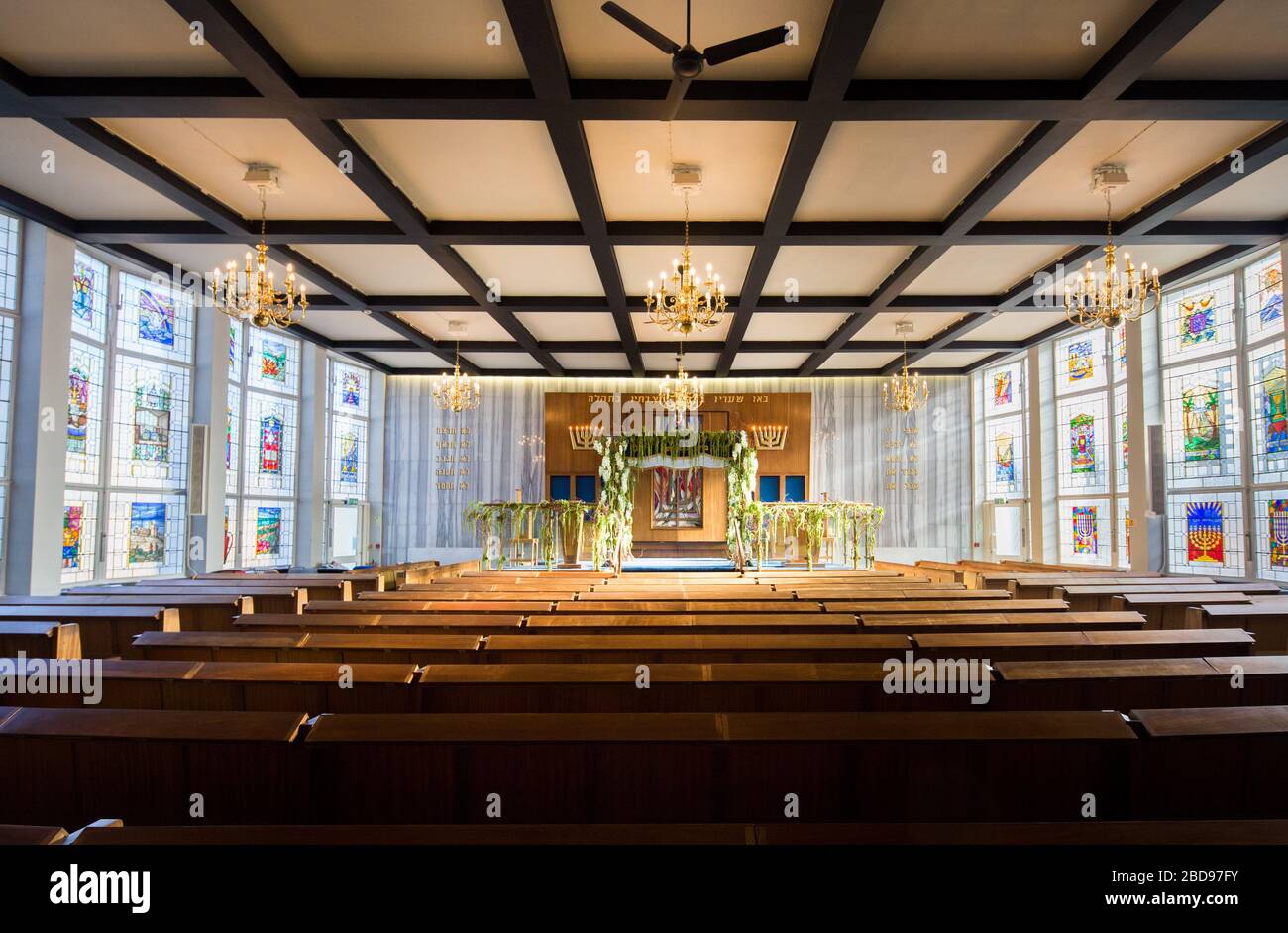 Bright, naturally illuminated Synagogue with chuppah made of flowers ...